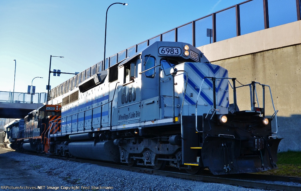 WE 6983 is pulling it's train out of the siding.